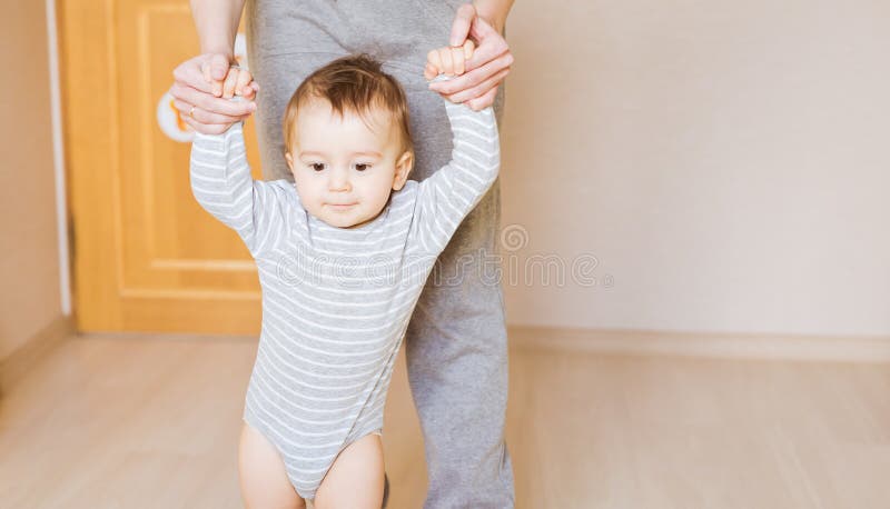 Baby Taking First Steps with Mother Help Stock Image - Image of learn ...