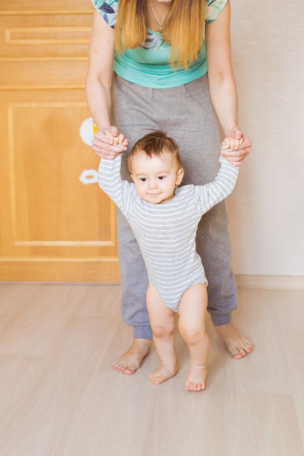 Baby Taking First Steps with Mother Help Stock Image - Image of life ...