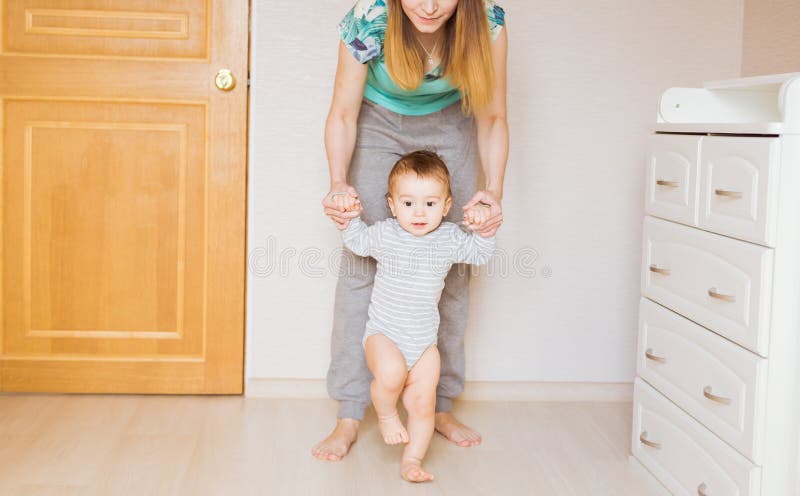 Baby Taking First Steps with Mother Help Stock Image - Image of help ...
