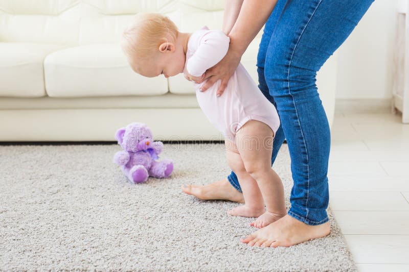 Baby Taking First Steps with Mother`s Help at Home Stock Photo - Image ...