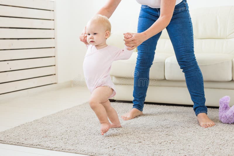 Baby Taking First Steps with Mother`s Help at Home Stock Image - Image ...