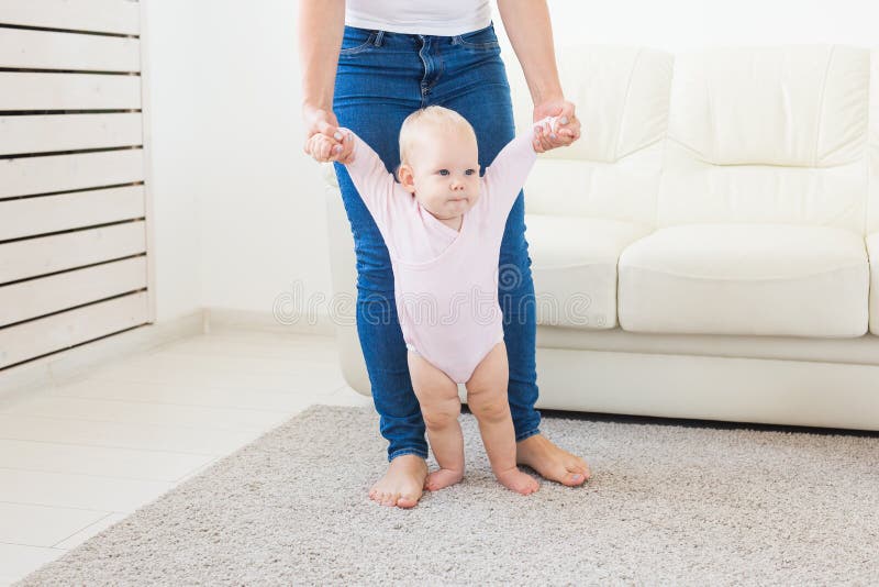 Baby Taking First Steps with Mother Help Stock Photo - Image of joyful ...