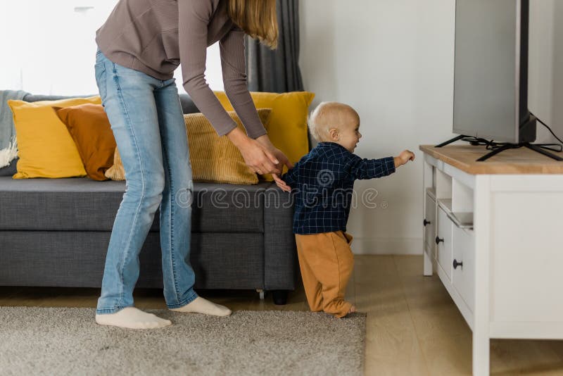 Baby Taking First Steps with Mother& X27;s Help at Home Stock Image ...