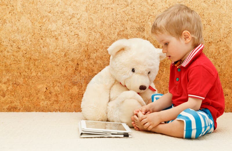 Baby and Teddy with Touch Pad Stock Photo - Image of line, indoors ...