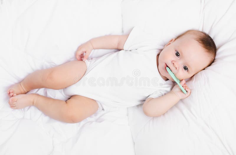 A Baby with a Teether on a White Background . Teething. Children& X27;s ...