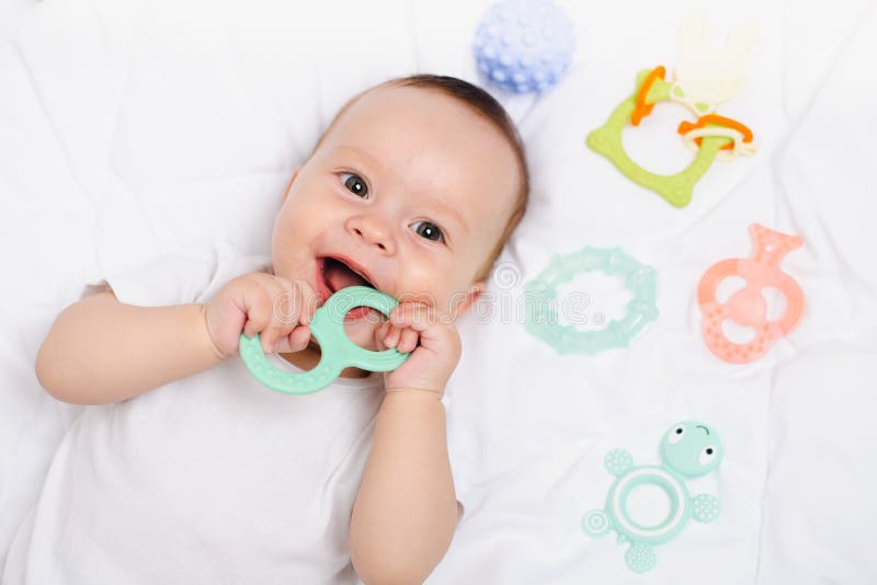 A Baby with a Teether on a White Background . Teething. Children& X27;s ...