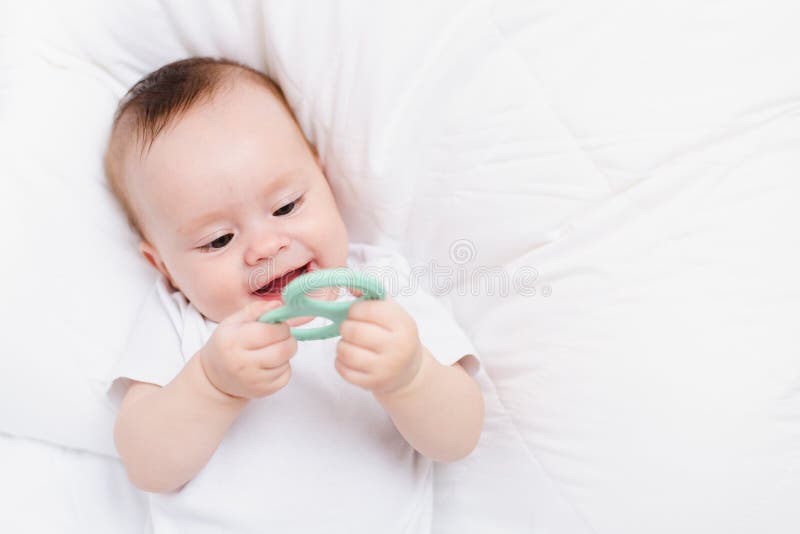 A Baby with a Teether on a White Background . Teething. Children& X27;s ...