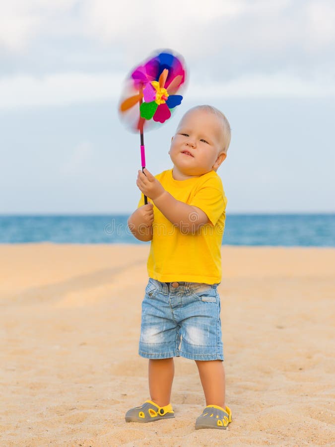 Baby with toy windmill stock image. Image of conceptual - 46984721
