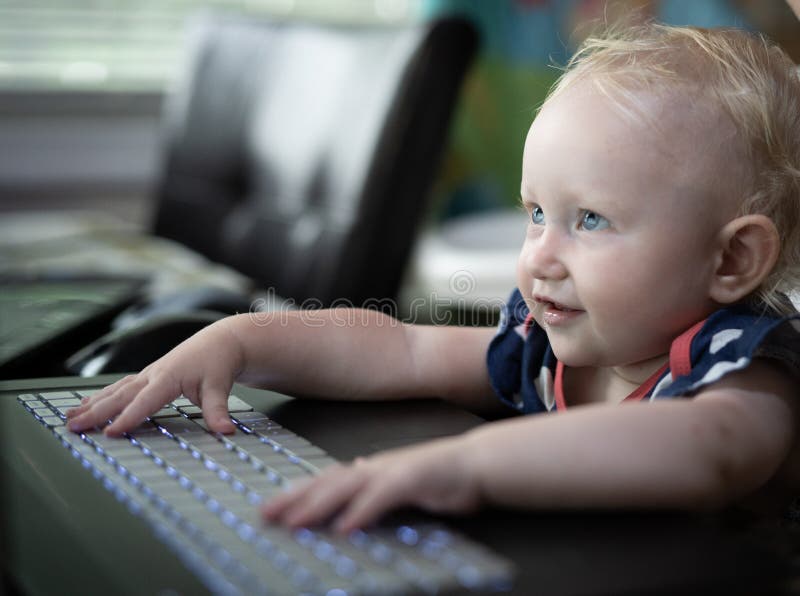 Baby Boy Typing On A Laptop Computer Stock Photo - Image of onesy ...