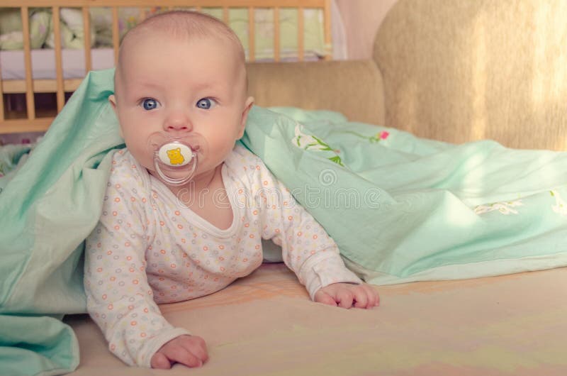Baby under blanket stock image. Image of happy, childhood - 65855215