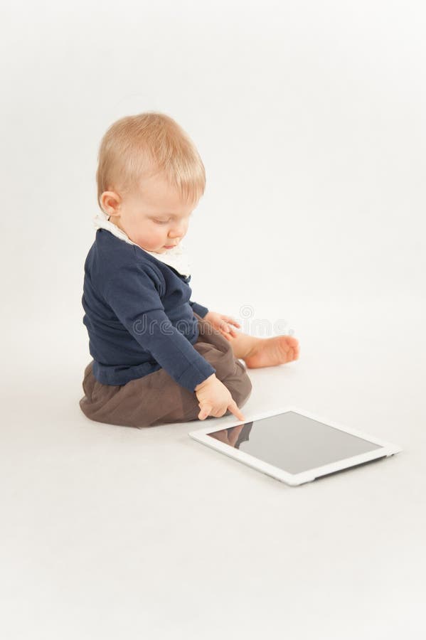 Baby using digital tablet stock image. Image of looking - 30938475