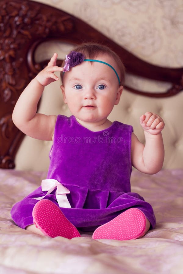 Baby in Violet Dress Touching Her Headband Stock Photo - Image of ...