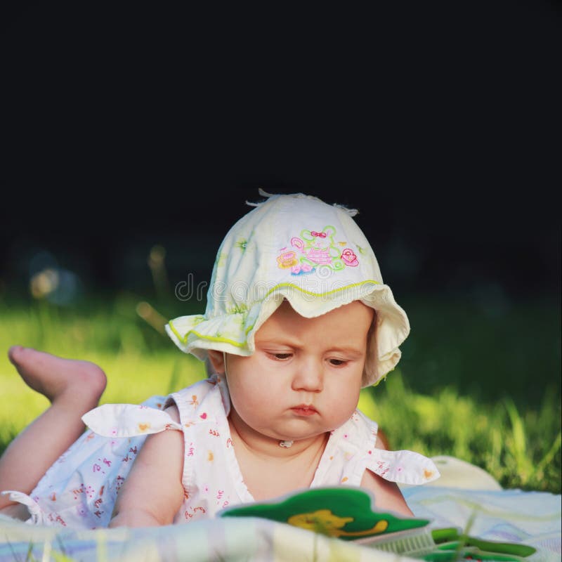 Baby is watching a book stock image. Image of girl, pretty - 42517671