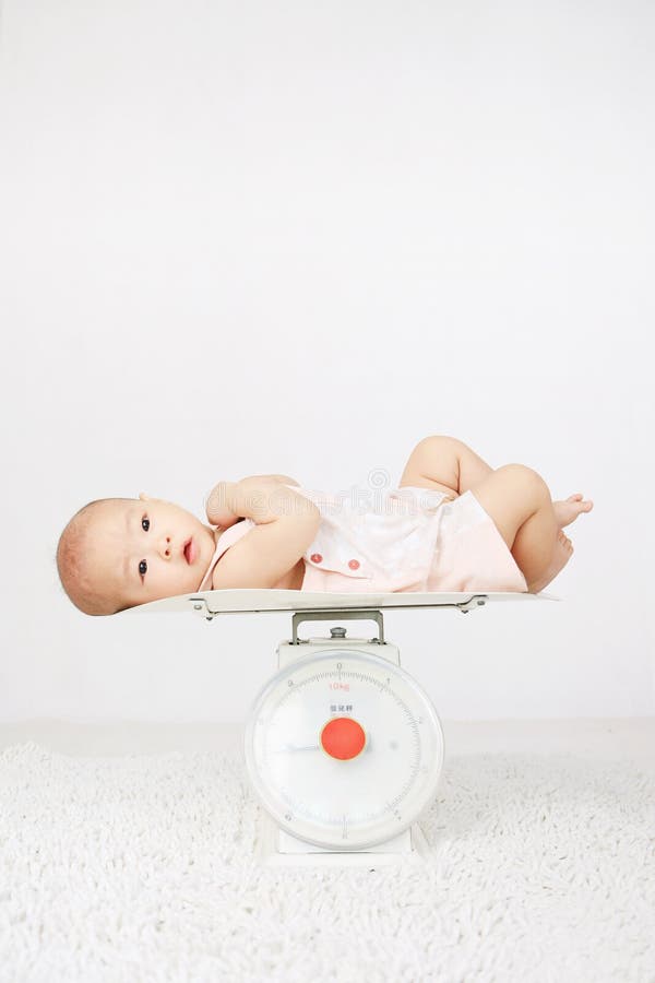Baby on on weighing scale stock photo. Image of child - 6001754