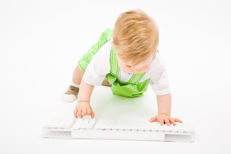 Baby with white keyboard stock image. Image of child - 10074357