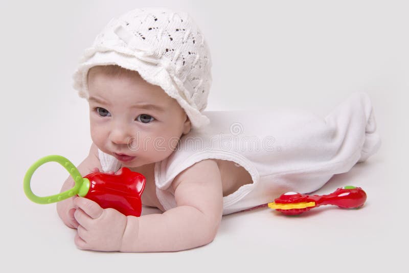 Baby on White Playing with Rattle Stock Image - Image of looking ...