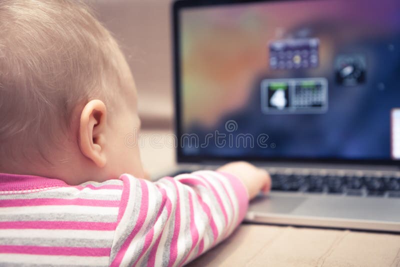 Baby Working on Laptop Computer with Hand Reaching To Touchpad Stock ...