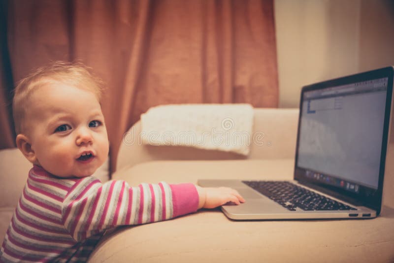 Baby Working on Laptop Computer Indoors Stock Photo - Image of child ...