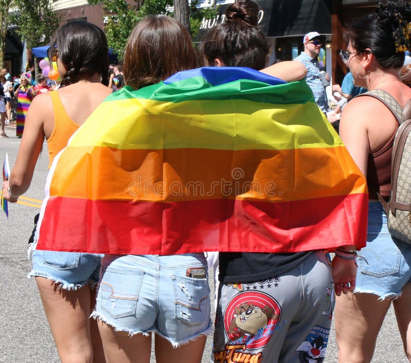 Couple Wrapped In A Rainbow Flag During A Gay Pride Parade Editorial