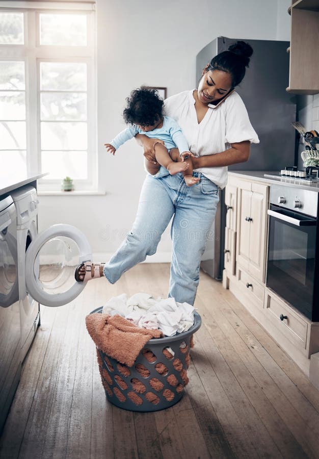 Babys Laundry Cannot Wait. a Young Mother Using a Cellphone while ...