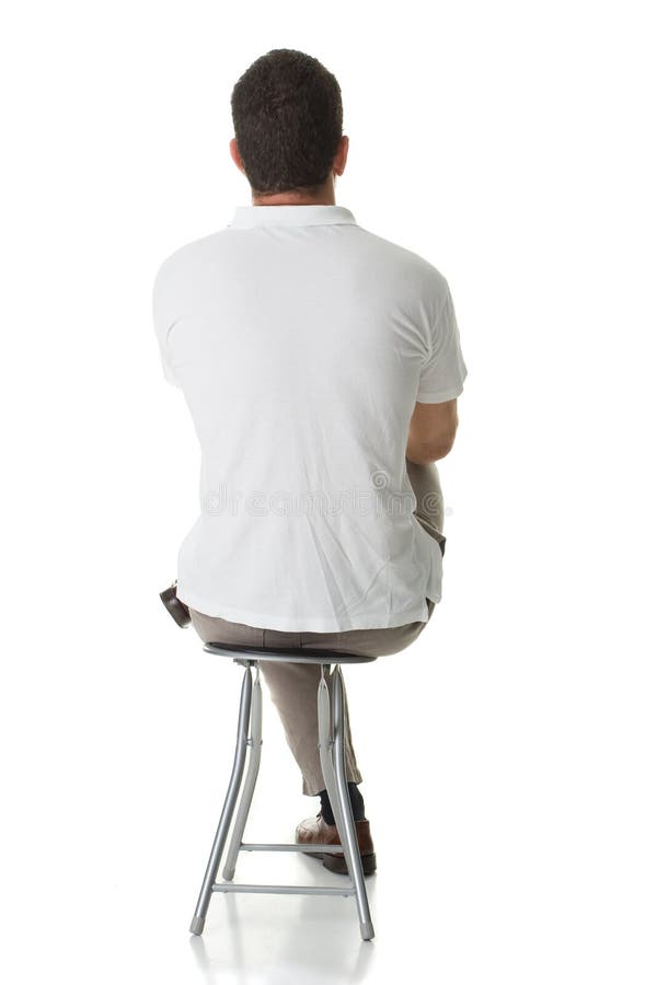 Back, An adult man sitting on a stool, with his back facing the camera ...