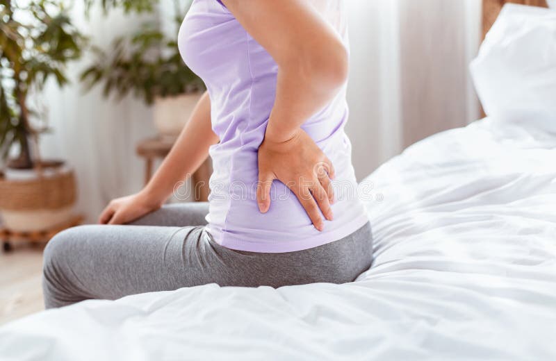 Unrecognizable Lady Touching Back Suffering from Pain Sitting on Bed ...