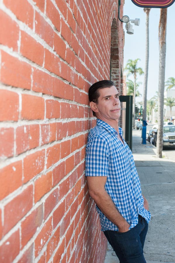 Comfortable Leaning Against the Wall. Stock Image - Image of standing ...