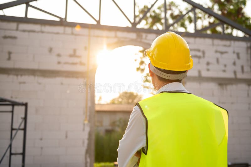 Back of Asian Engineering Man Looking To Construction Analyzing about ...