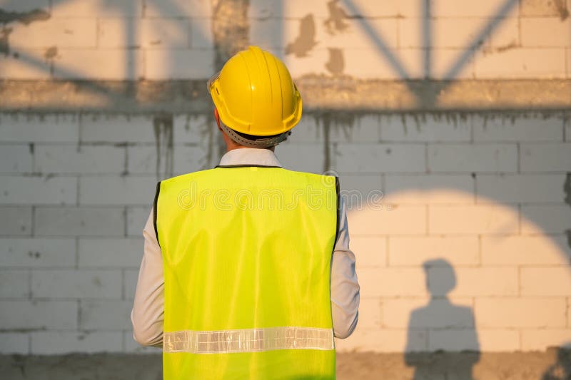 Back of Asian Engineering Man Looking To Construction Analyzing about ...