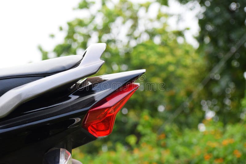 The Back Backlight of a Bike Parked in the Forest Stock Photo - Image ...