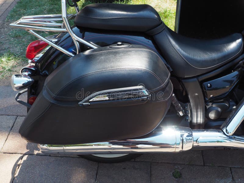 The Back of a Black Motorcycle with a Leather Seat Illuminated by ...