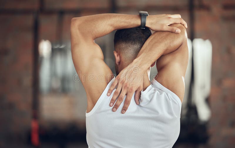 Back of a Bodybuilder Stretching before Exercise. Athlete Doing an Arm ...