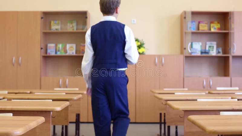 Back of Boy in Uniform Going among Desks in Stock Video - Video of form ...