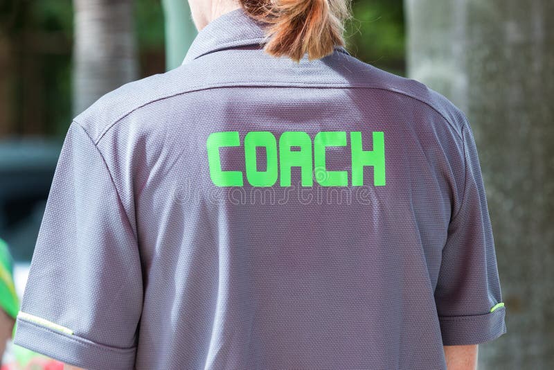 Back of a Coach`s Grey Shirt with the Green Word Coach Written O Stock ...