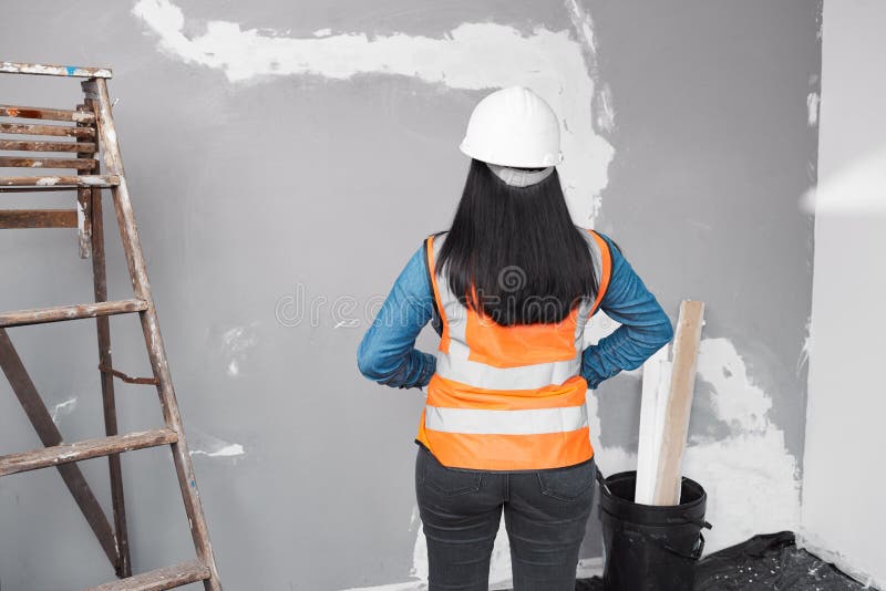 The Back of a Construction Worker in Uniform As she Faces Work in ...
