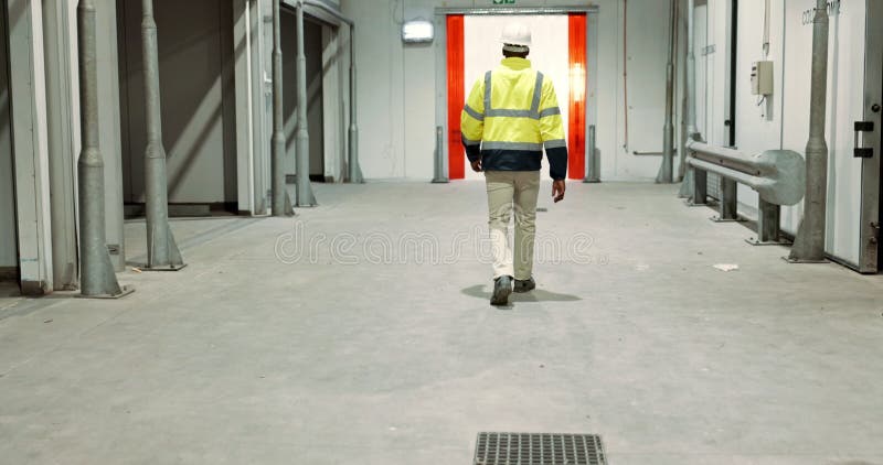 Back, Engineering and a Construction Worker Walking in a Warehouse for ...