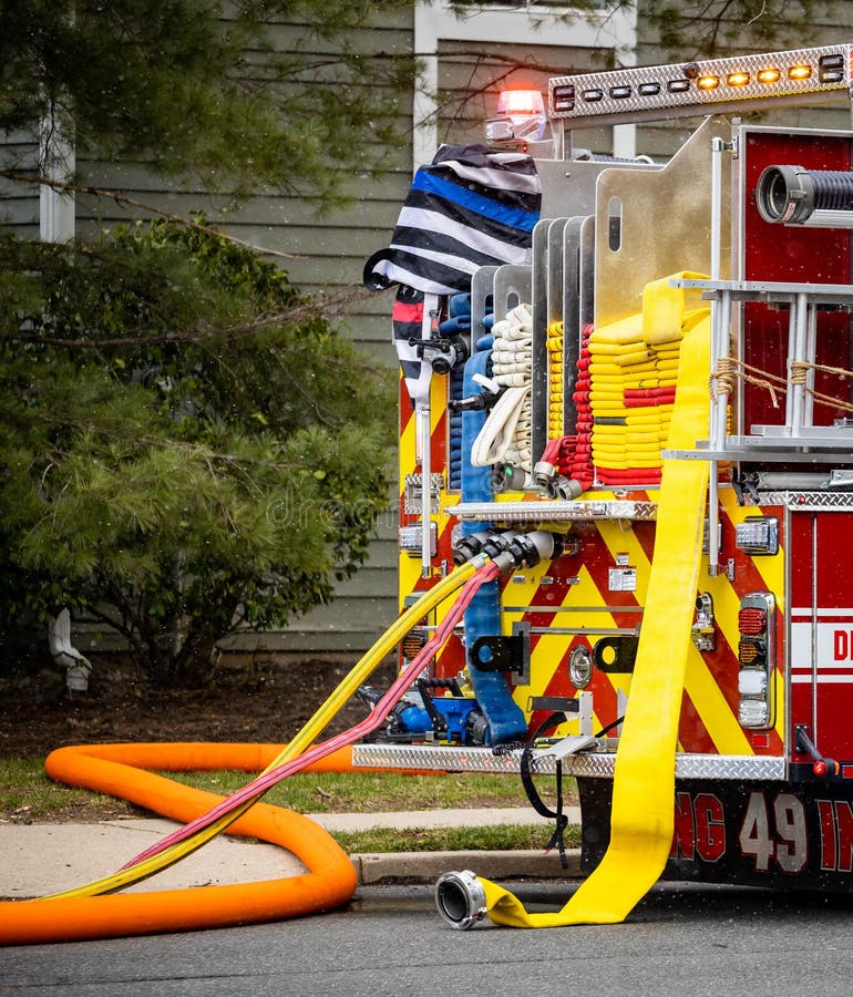 Back of the Firetruck with Hoses Equipment and Flag Stock Photo - Image ...