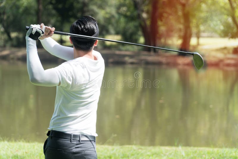 Back of Golf Player in White Shirt Swinging Glof. Young Man Practicing ...