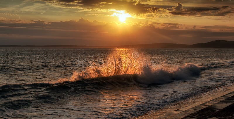 Back lit crashing wave stock image. Image of splash, seascape - 98510037