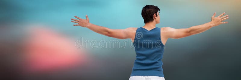Back of Man in Training Gear with Arms Out Against Blurry Blue ...