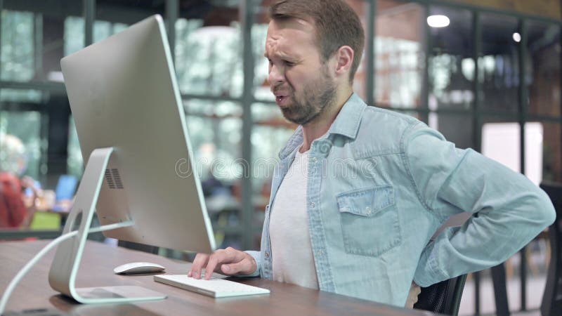 Back Pain, Uncomfortable Man Working on Computer at Work Stock Photo ...
