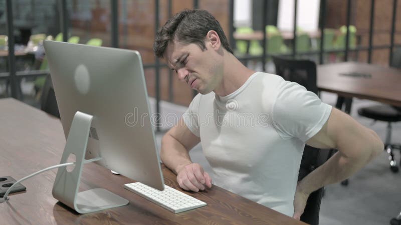 Back Pain, Uncomfortable Young Man Working on Computer Stock Footage ...
