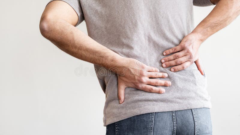 Back Pain. Young Man Suffering from Muscle Pain and Strain Over Light ...