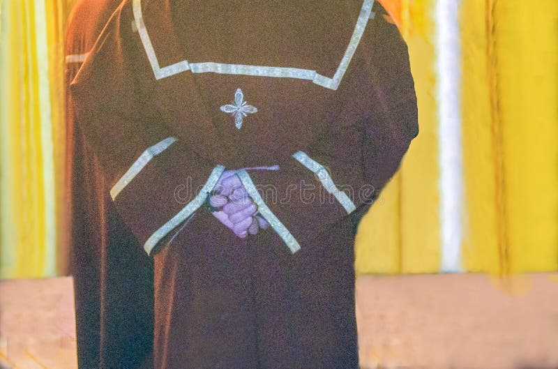 The Back of a Priest in a Cassock with a Rosary in His Hands Stock ...