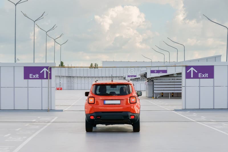 The Back of a Red Car in an Open Parking Lot Stock Image - Image of ...