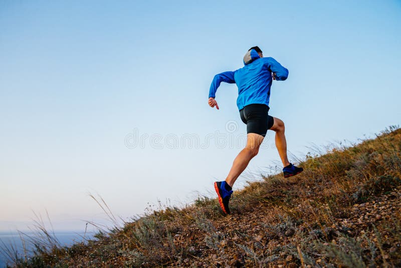 Back Athlete Runner in Blue Shirt and Black Tights Running Mountain ...