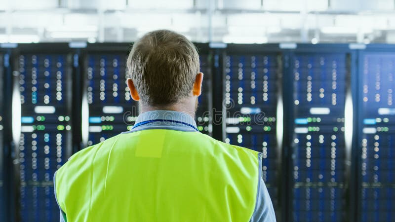 Back Shot of an it Administrator in High Visibility Vest Walking ...