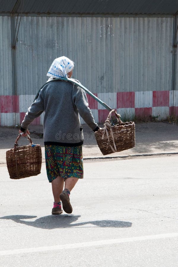 Back Shot of an Old Woman Carrying Straw Baskets Editorial Image ...