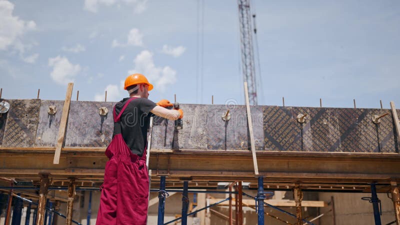 Back Shot of Professional Construction Worker in Hard Hat and Bib ...