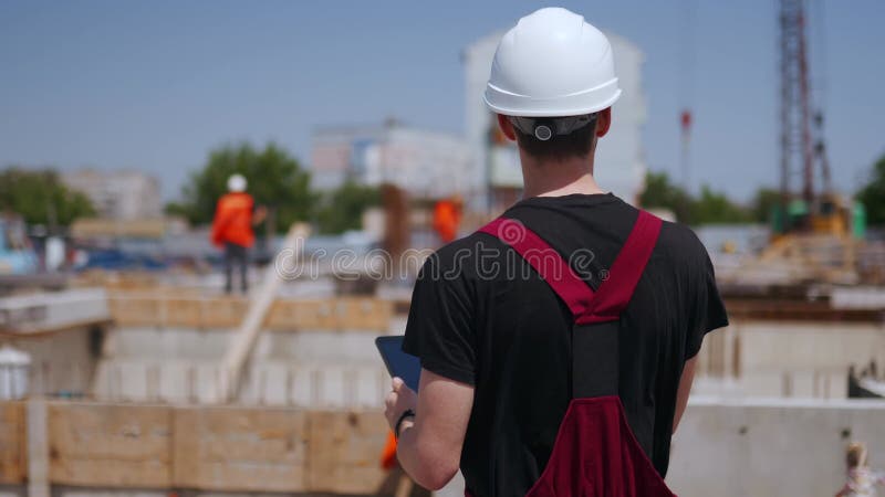 Side Shot of Professional Construction Worker Wearing Hard Hat Holds ...